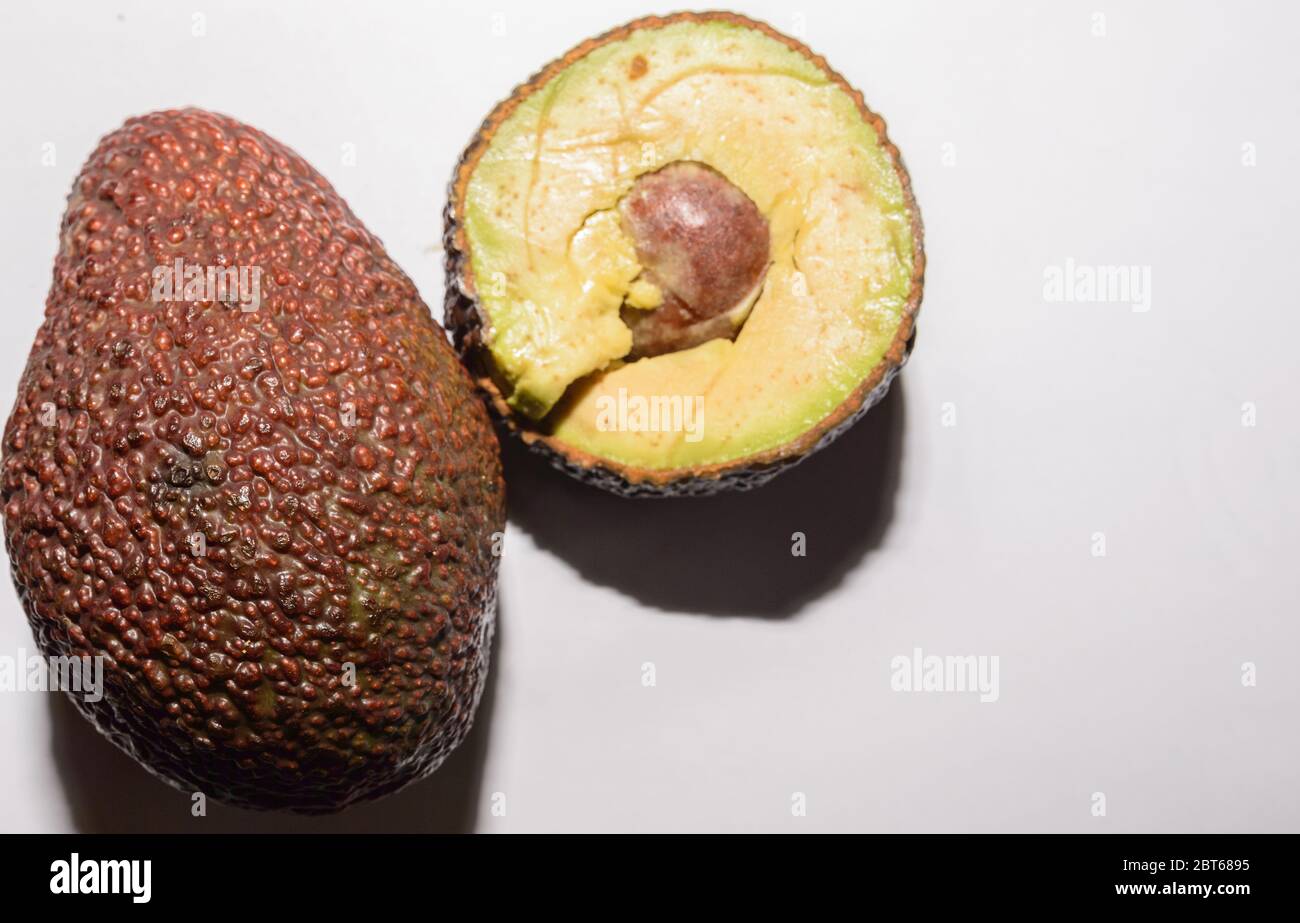 Fresh Two Avocados One Open Half Stock Photo - Alamy
