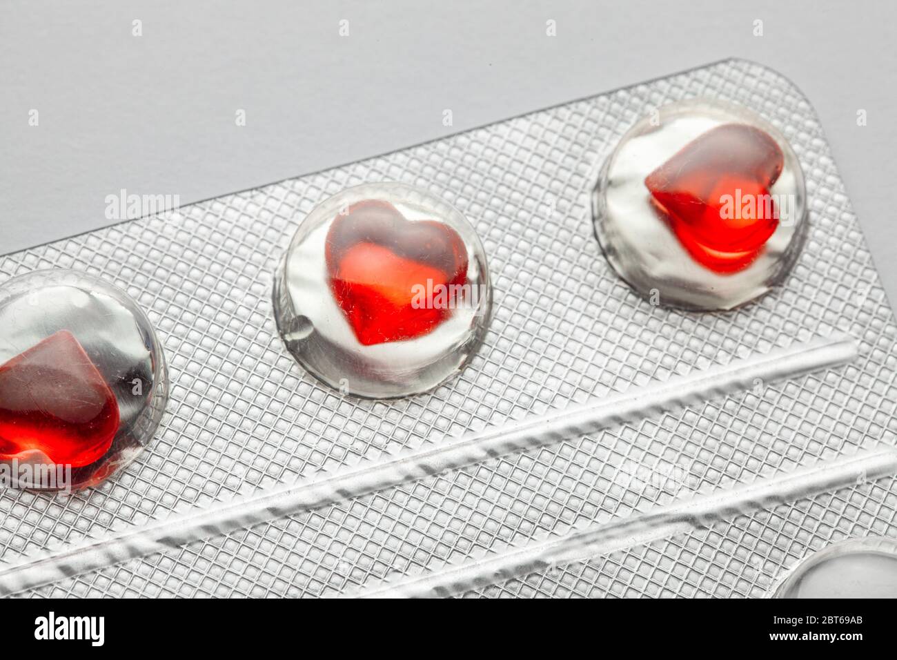 Love pills. Blister pack with red heart shaped pills. Tablets for ...