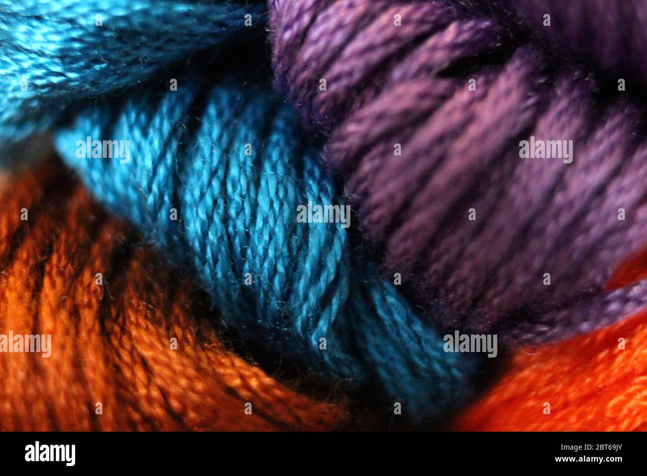 A close up photograph of sewing yarn in multi colours Stock Photo - Alamy