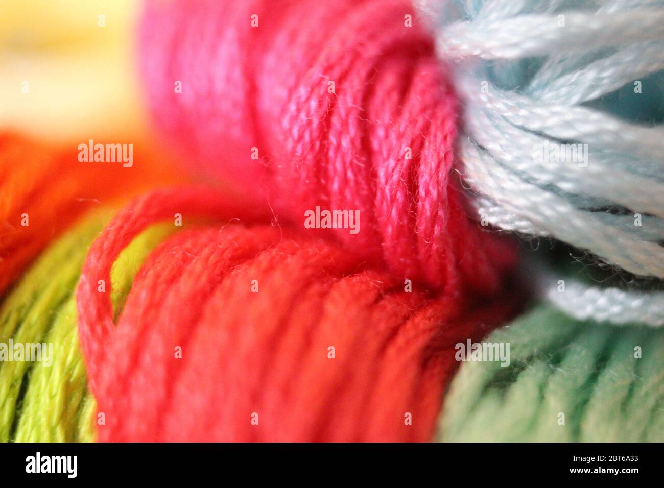 A close up photograph of sewing yarn in multi colours Stock Photo - Alamy