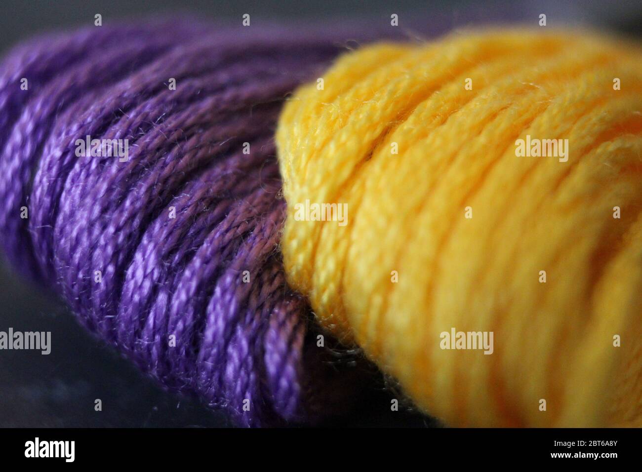 A close up photograph of sewing yarn in multi colours Stock Photo - Alamy