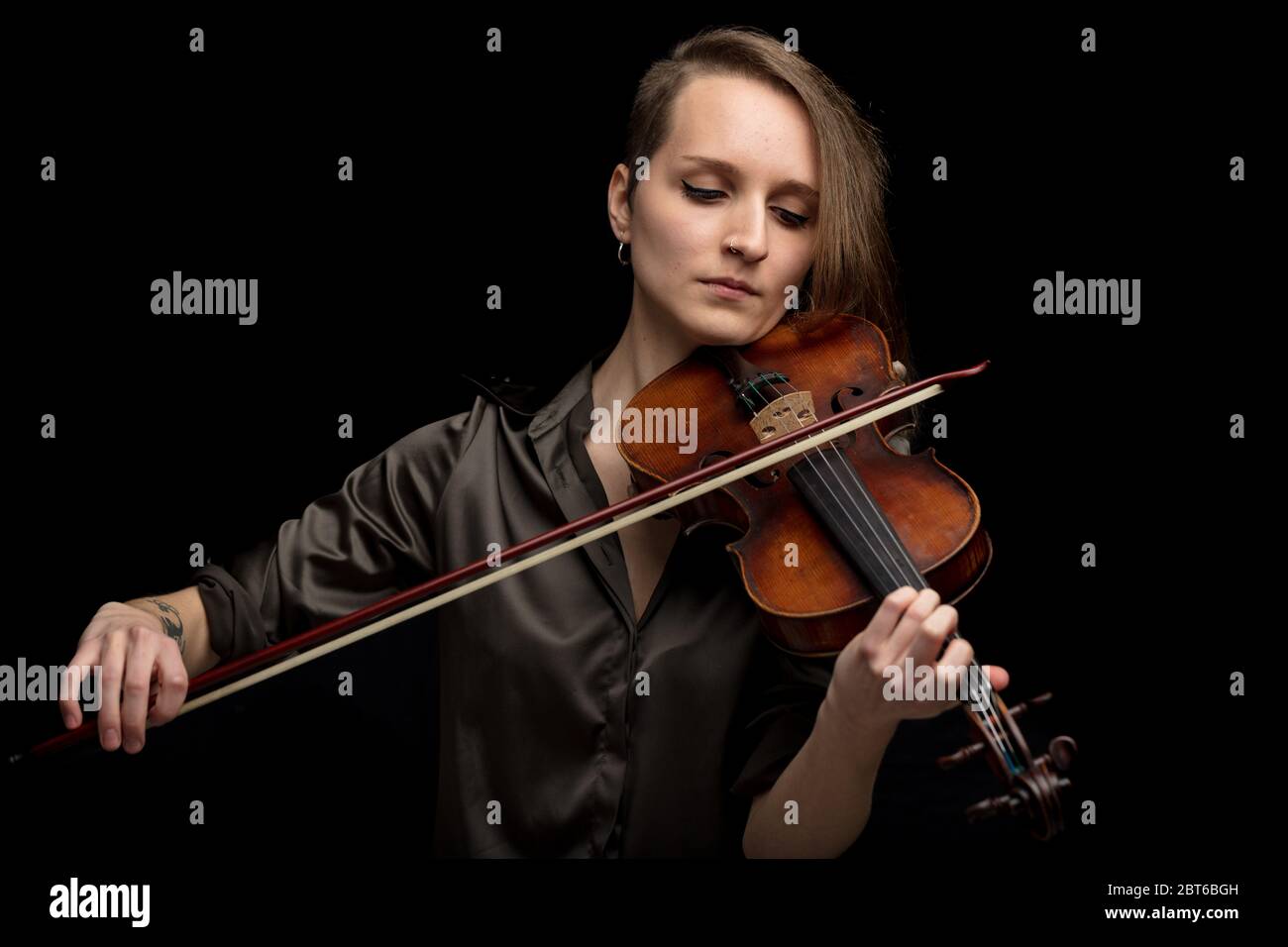 Professional female violinist playing in a concert or orchestral ...