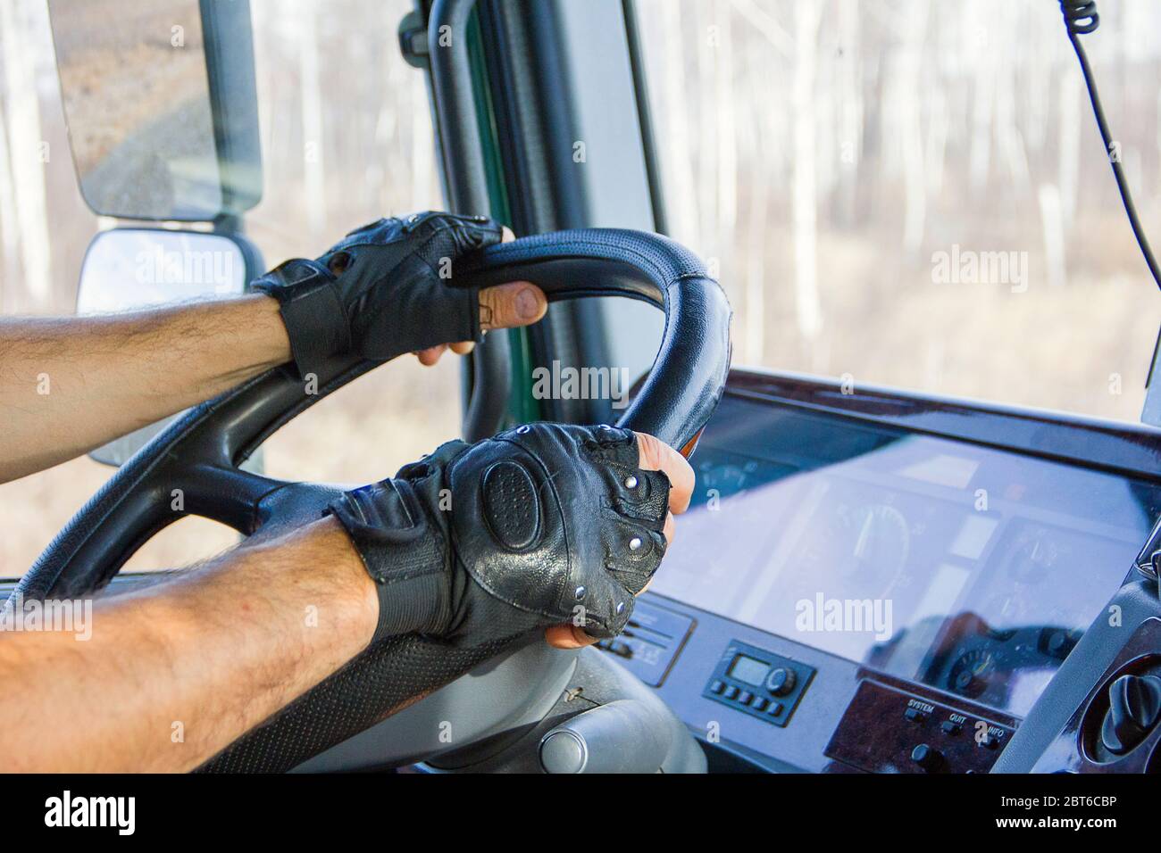 Truck driving. Caucasian male trucker holding both hands on the ...