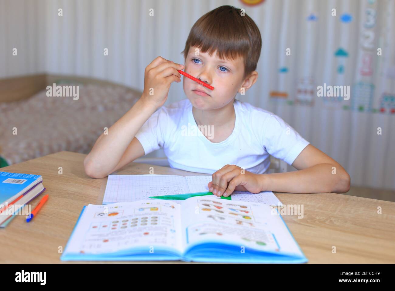 A child does homework on isolation. Homework Stock Photo - Alamy