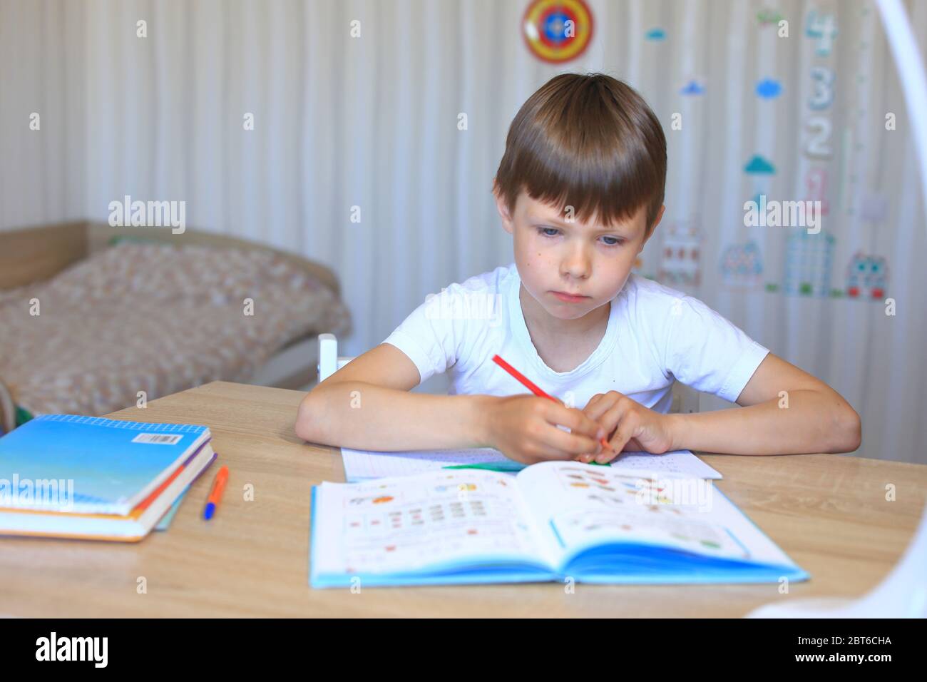 A child does homework on isolation. Homework Stock Photo - Alamy
