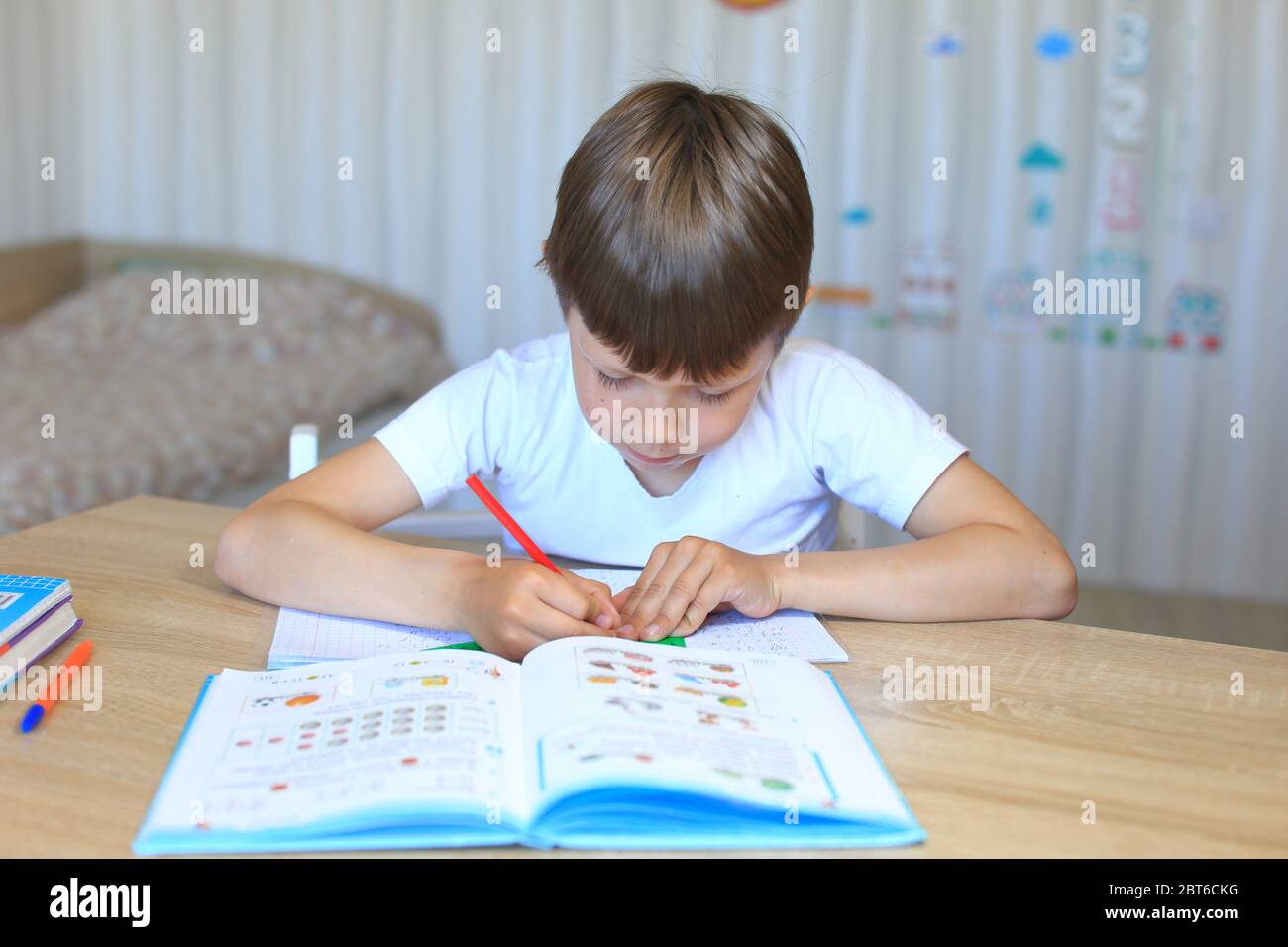 A child does homework on isolation. Homework Stock Photo - Alamy