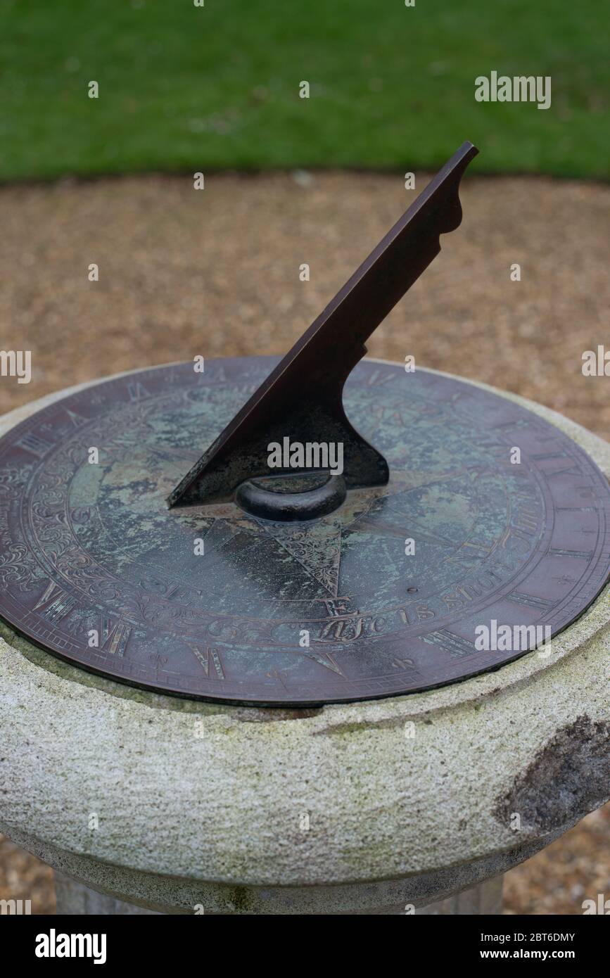 a metal sundial in a garden on a overcast day Stock Photo - Alamy