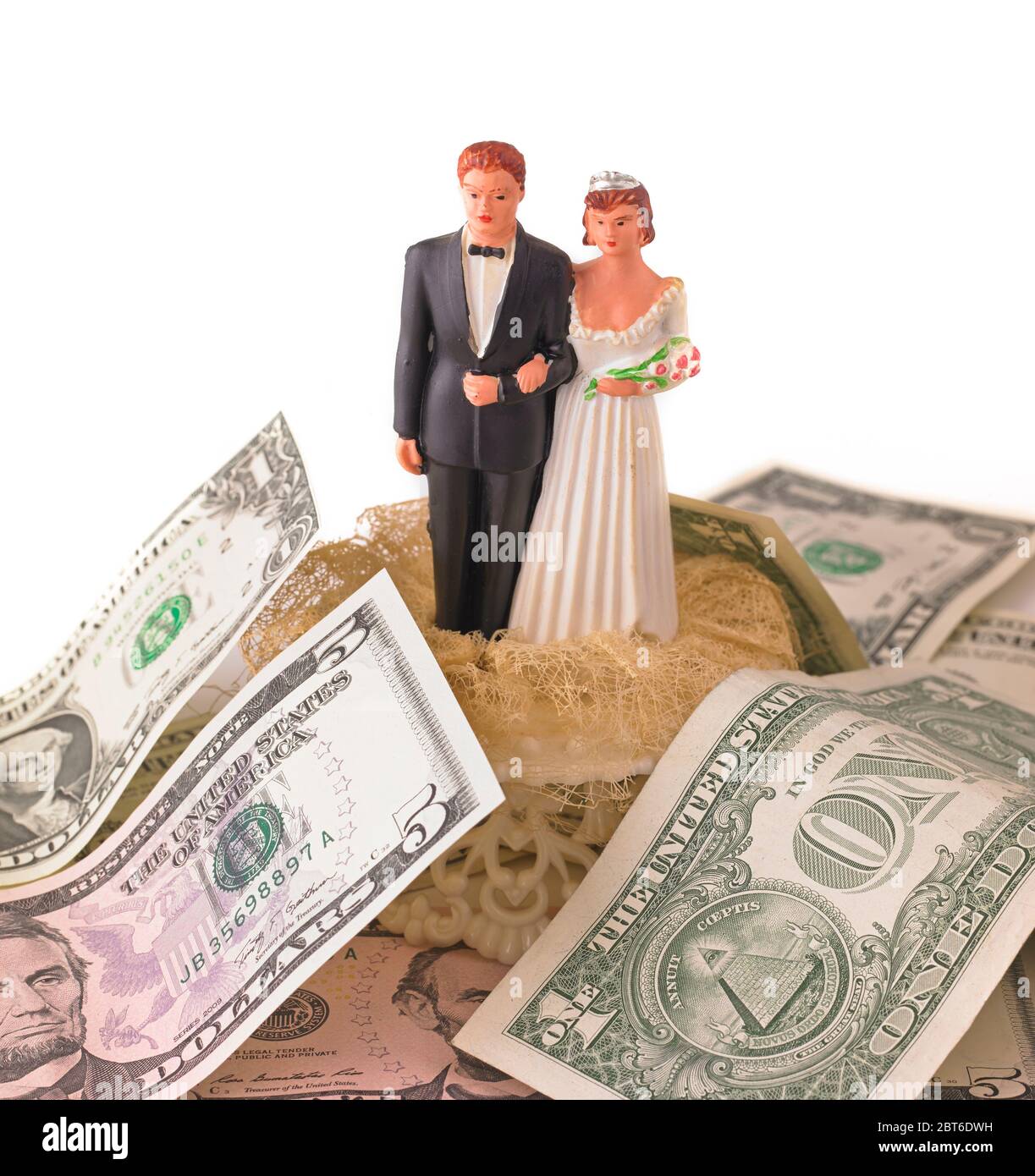 Bride and Groom wedding figures under pile of US Dollar banknotes Stock ...