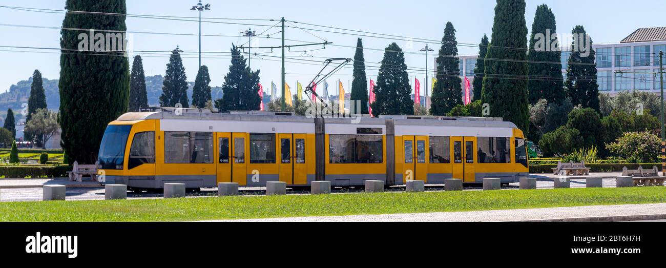 A modern tram ride down the city street. Transport system for ...