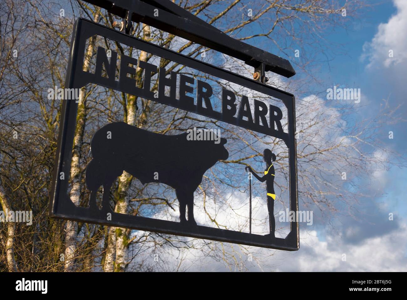 Humourous farm road end sign with bikini clad cattle herder Stock Photo ...