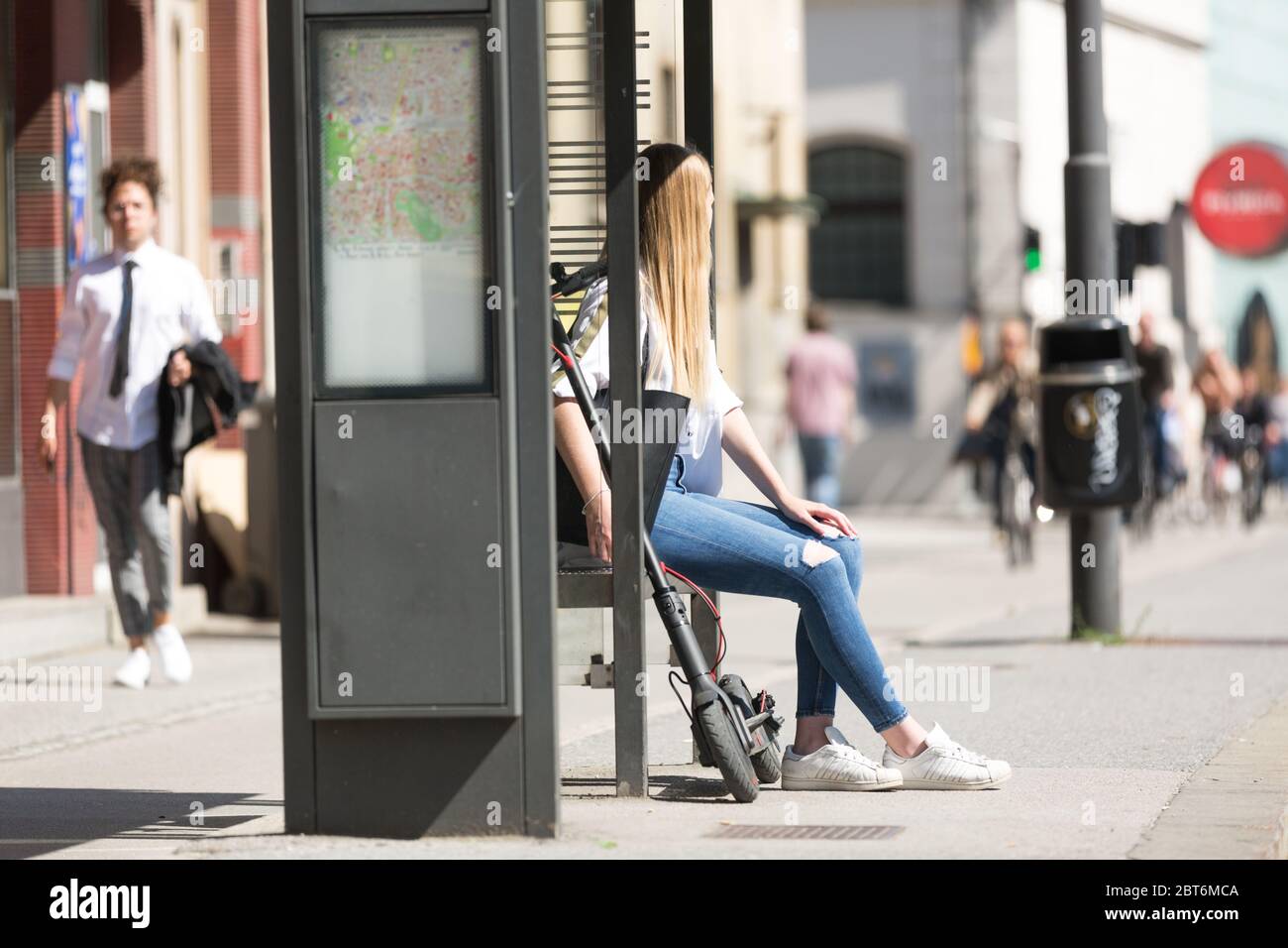 Casual caucasian teenager commuter with modern foldable urban electric ...
