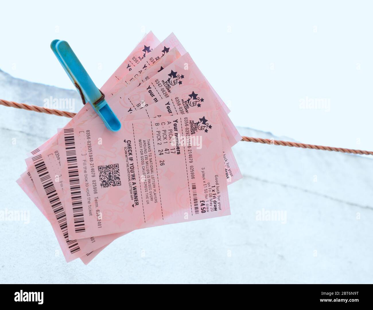 Euromillion lottery tickets are clipped on washing line Stock Photo - Alamy