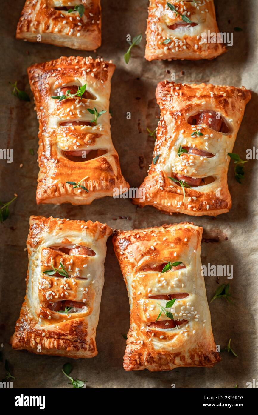 Top down view of sausage in puff pastry with herbs Stock Photo - Alamy