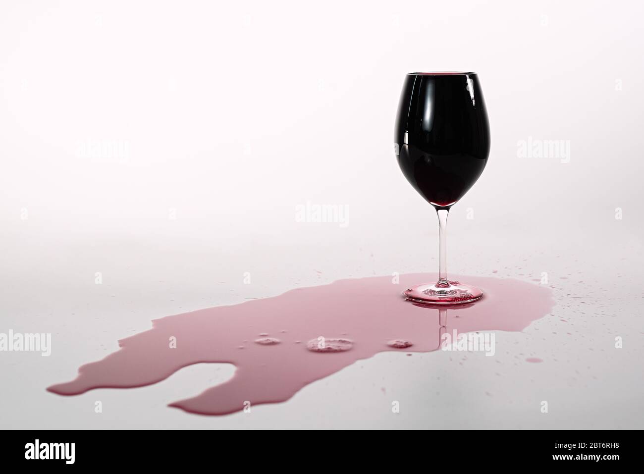 The Glass With Red Wine Is Full The Wine Is Poured On A White Table The Full Glass Of Red Wine