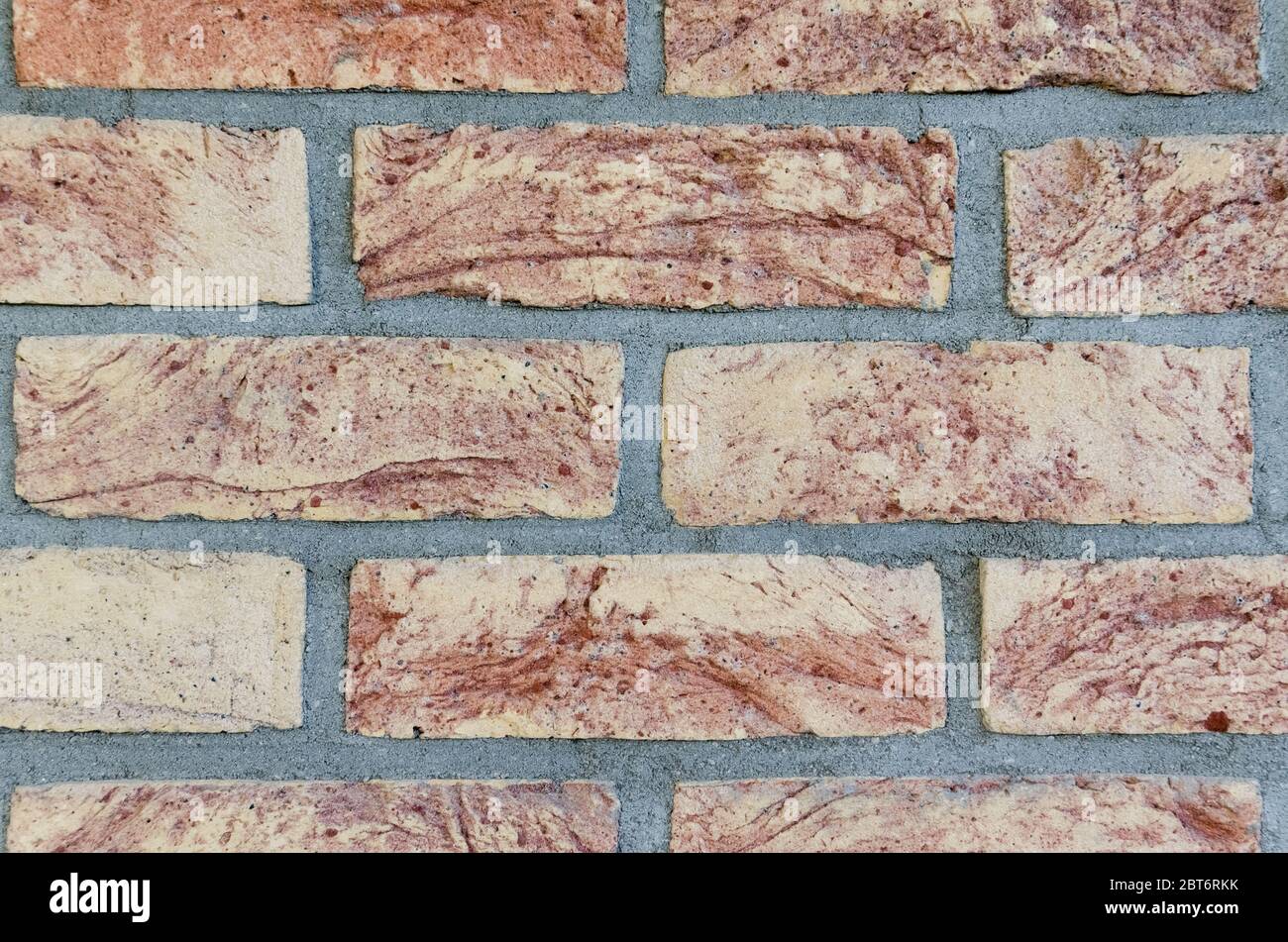 Close up of red and orange brick wall, front view, full frame ...