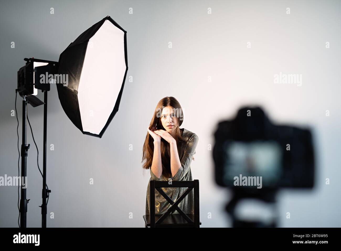 a girl poses in front of the camera of the camera, a lantern is ...