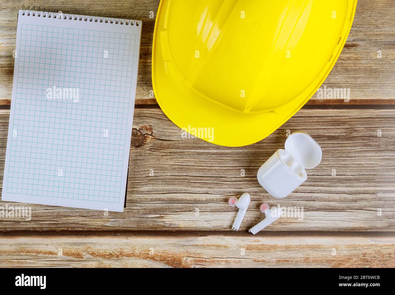 Engineers maintenance office construction, yellow hard hat with notepad ...