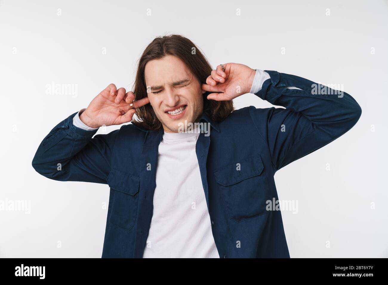 Image of stressed caucasian man with long hair looking upward and ...