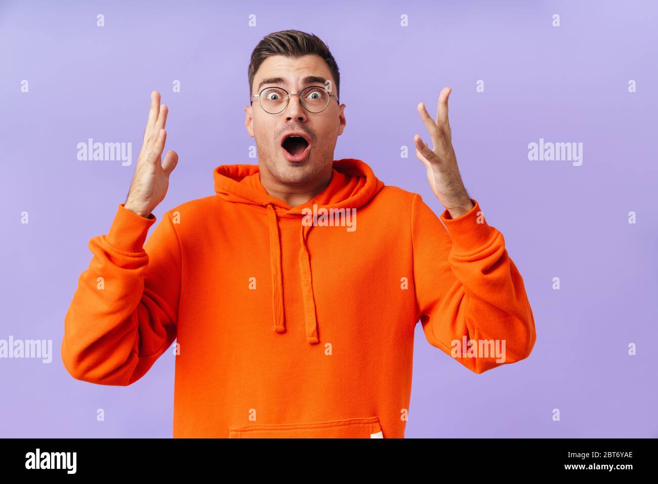 Photo of shocked screaming young man isolated over purple background ...