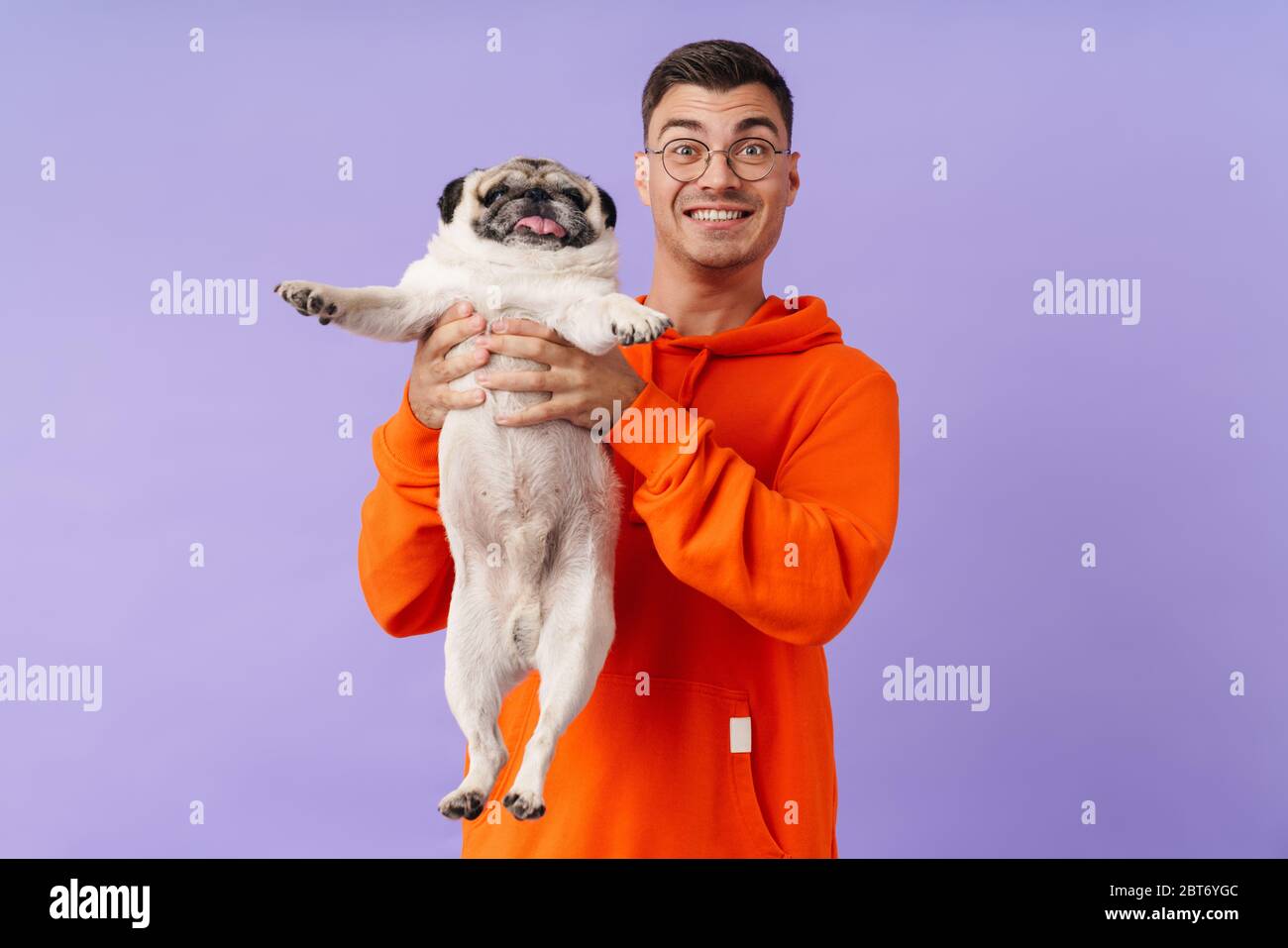 Photo of happy cheery optimistic man posing isolated over purple ...