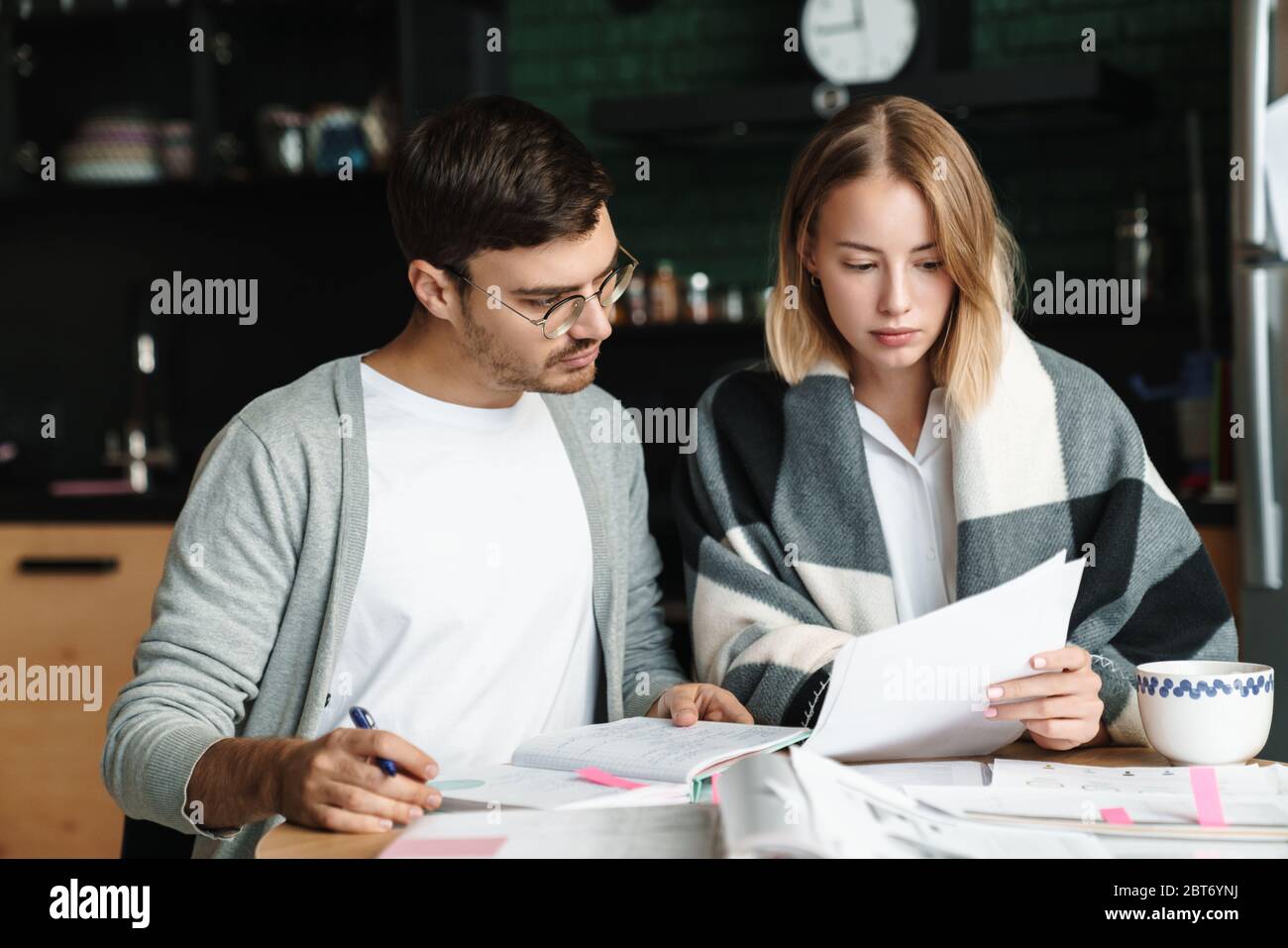 Image of happy young businesslike man and woman doing calculations and ...