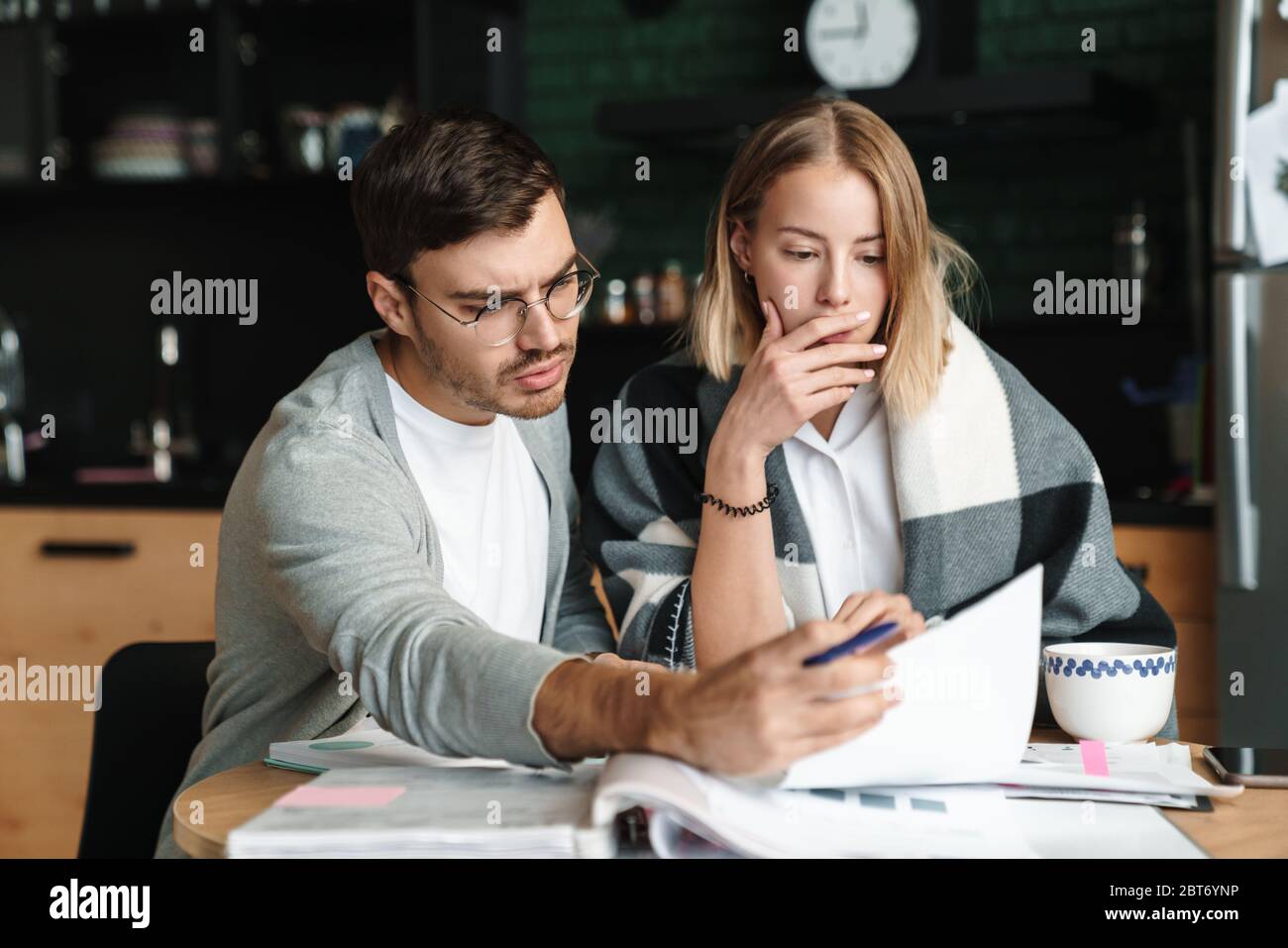 Image of happy young businesslike man and woman doing calculations and ...