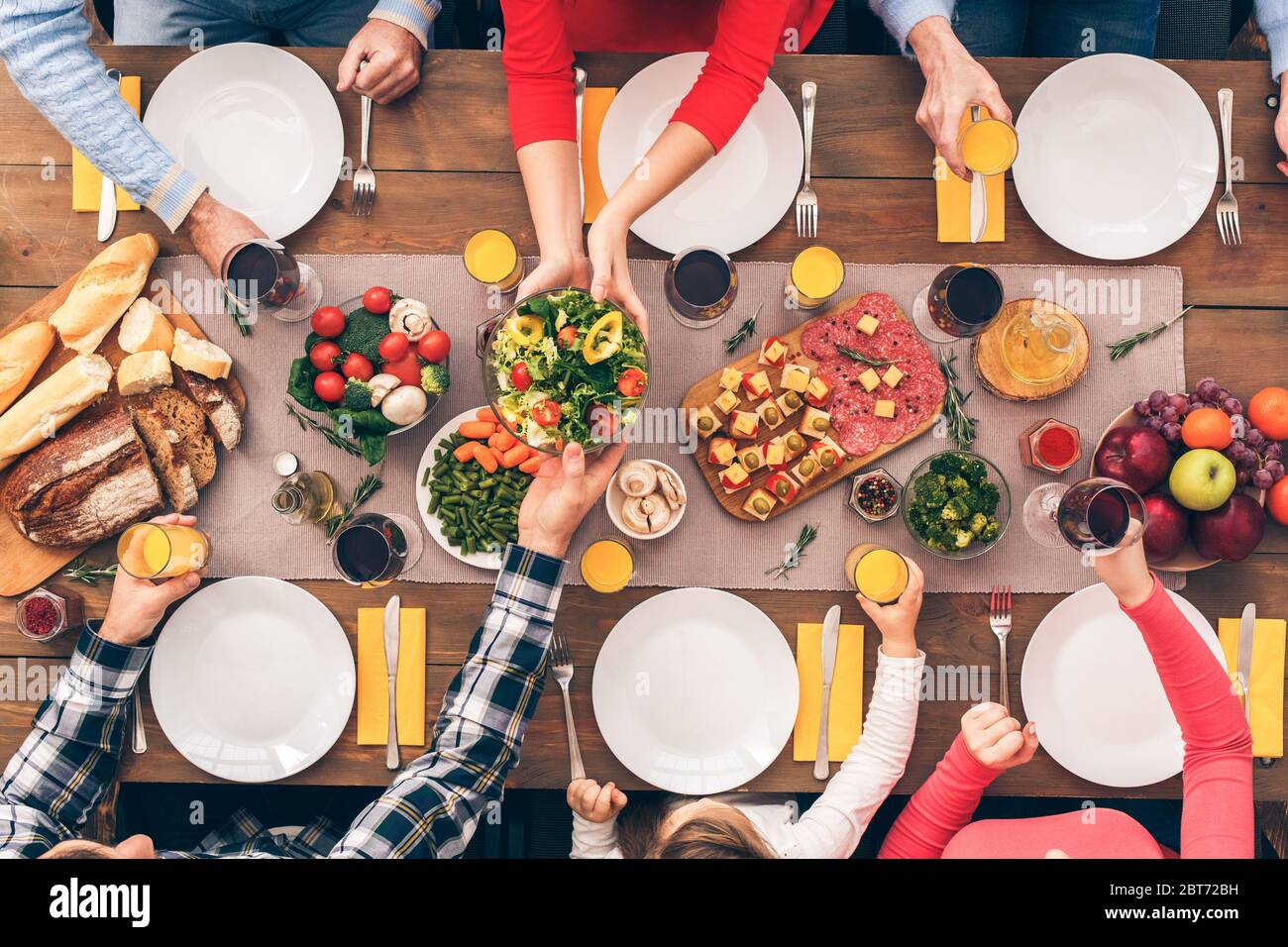 Colorful picture. Big family starts lunch or dinner Stock Photo - Alamy