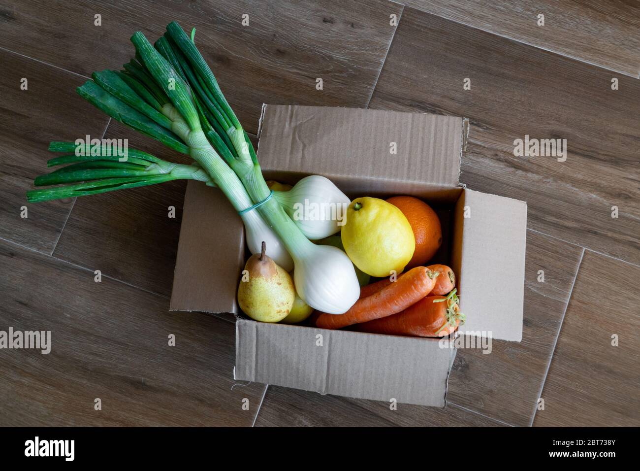 Fresh vegetables in cardboard box on brown wood background Stock Photo ...