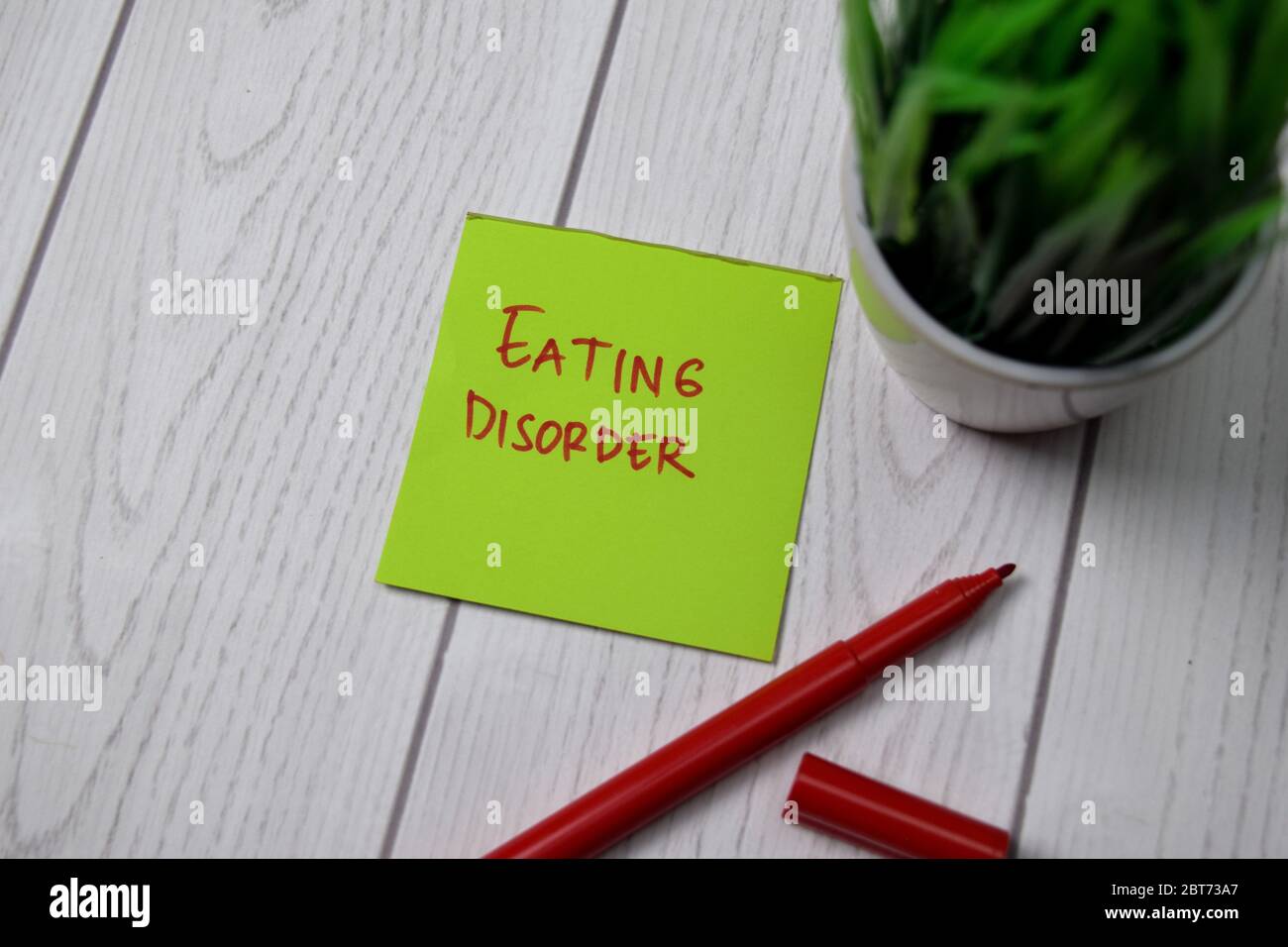 Eating Disorder write on sticky note isolated on wooden table Stock ...