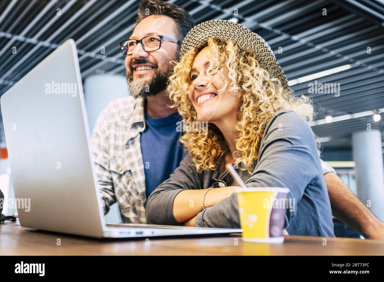 Happy and cheerful people couple of modern young adult worker with ...