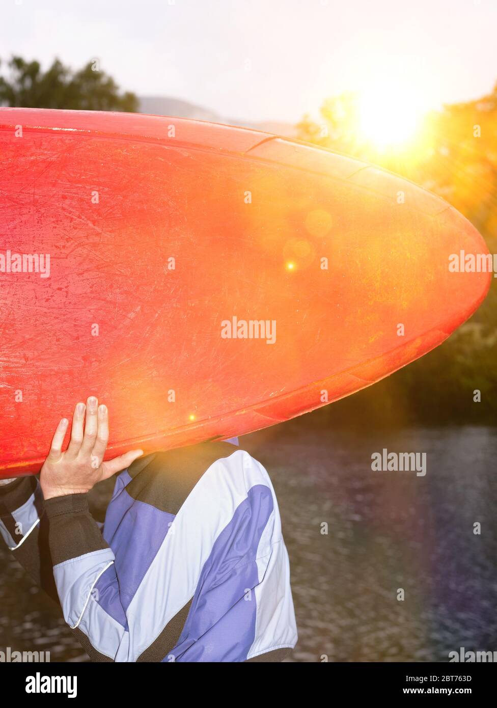 Man carrying kayak outdoors Stock Photo - Alamy