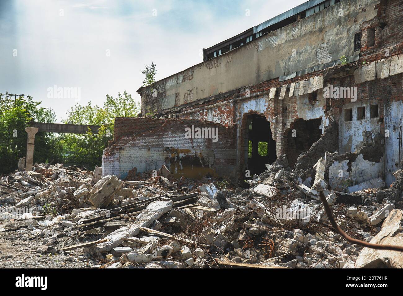 Ruined abandoned building with large pills of concrete garbage ...