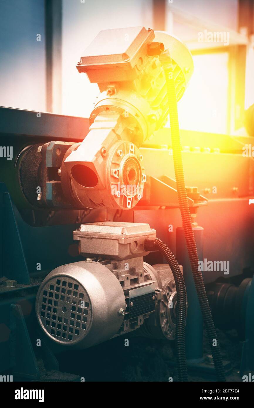 Industrial machine tool equipment close up in sunlight flare, industry ...