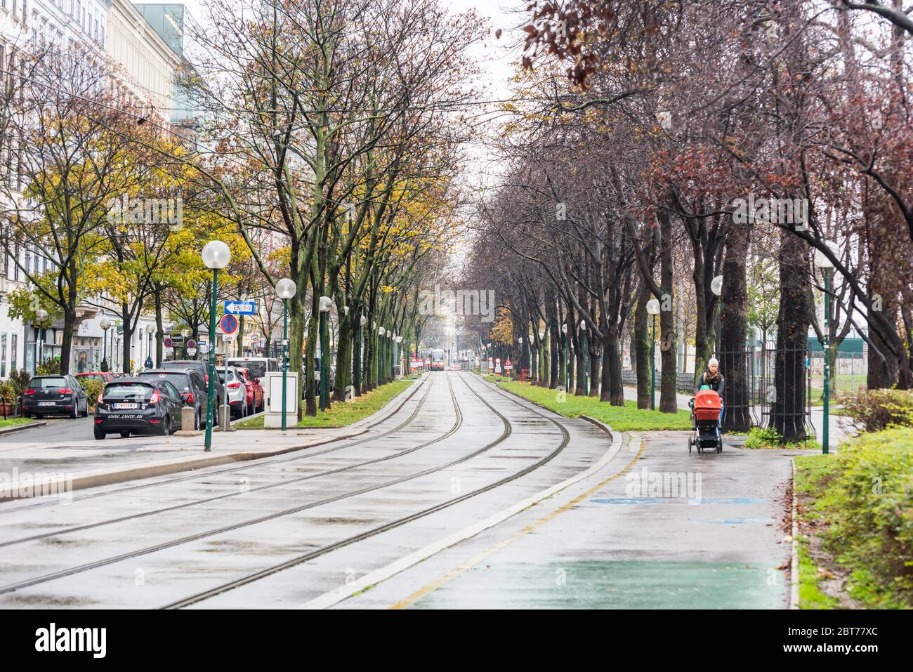 Street view of railway for tram with trees in a rainy day, in the old ...