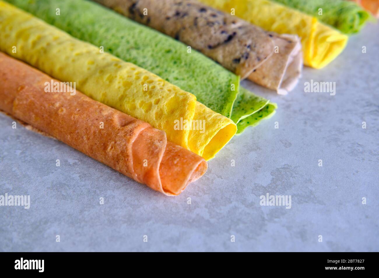 Pancakes of different color. Spinach, beetroot powder, blueberry and ...