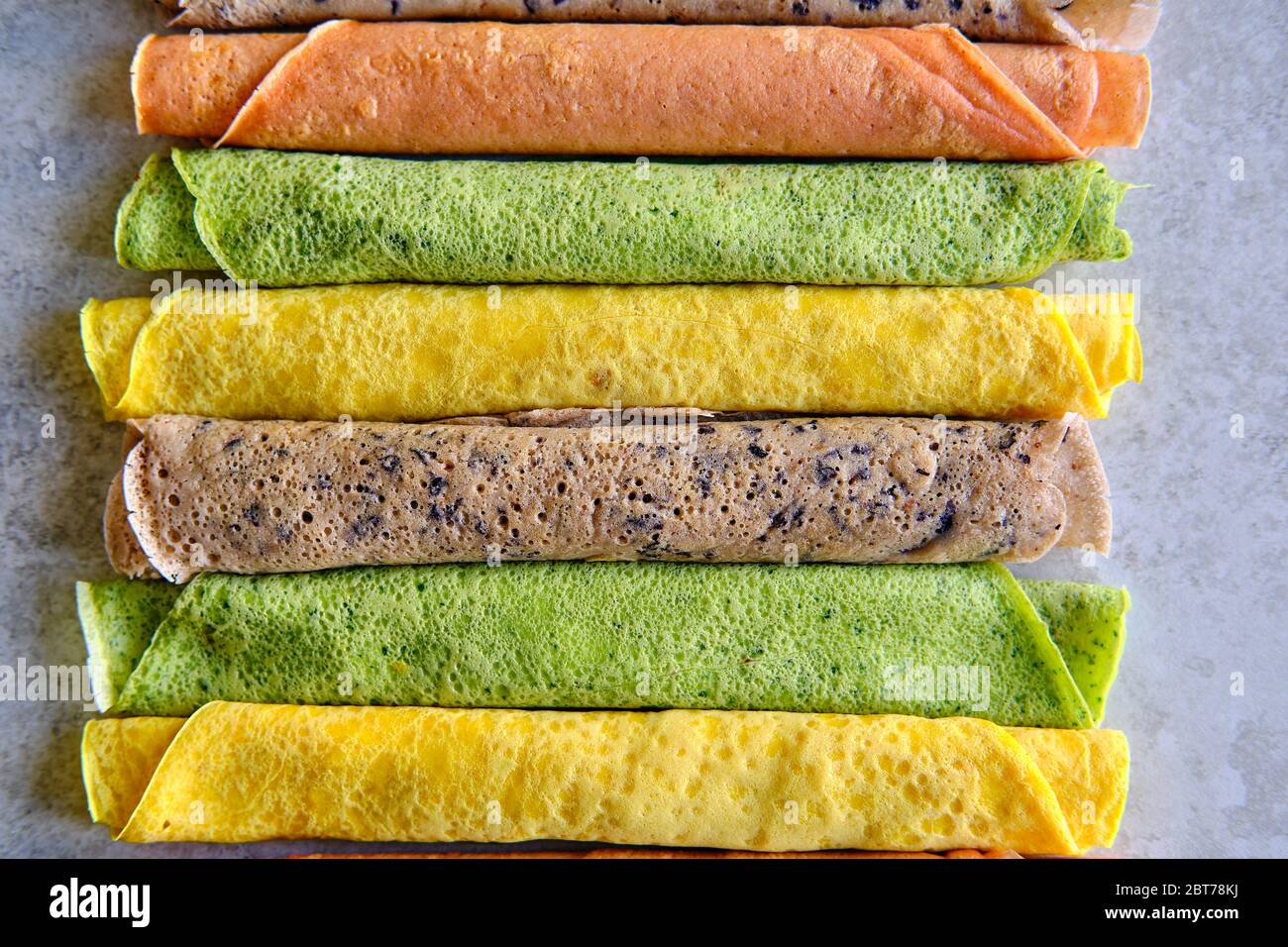 Pancakes of different color. Spinach, beetroot powder, blueberry and ...