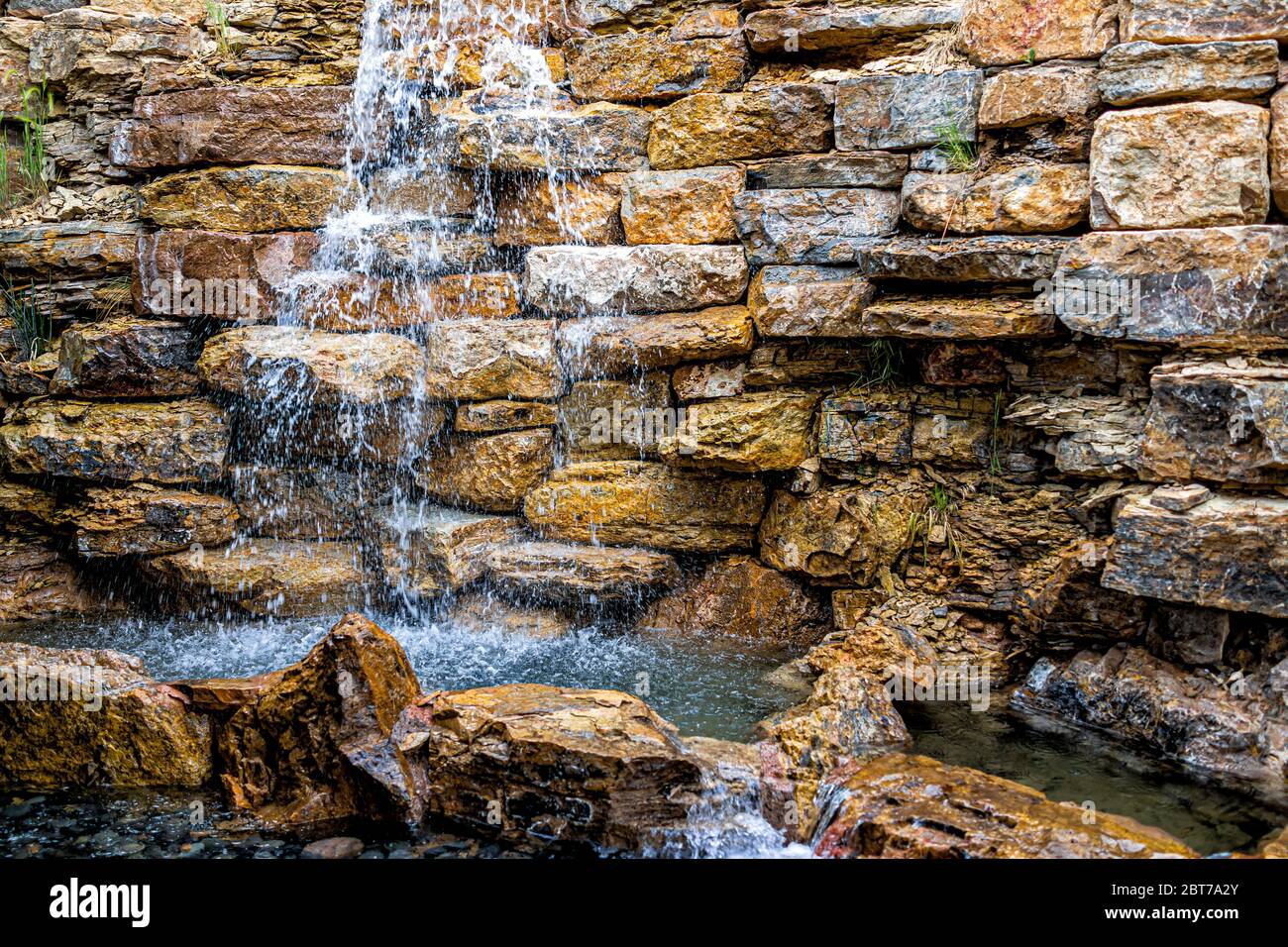 Waterfall with flowing water in Japanese garden with stones and rocks ...