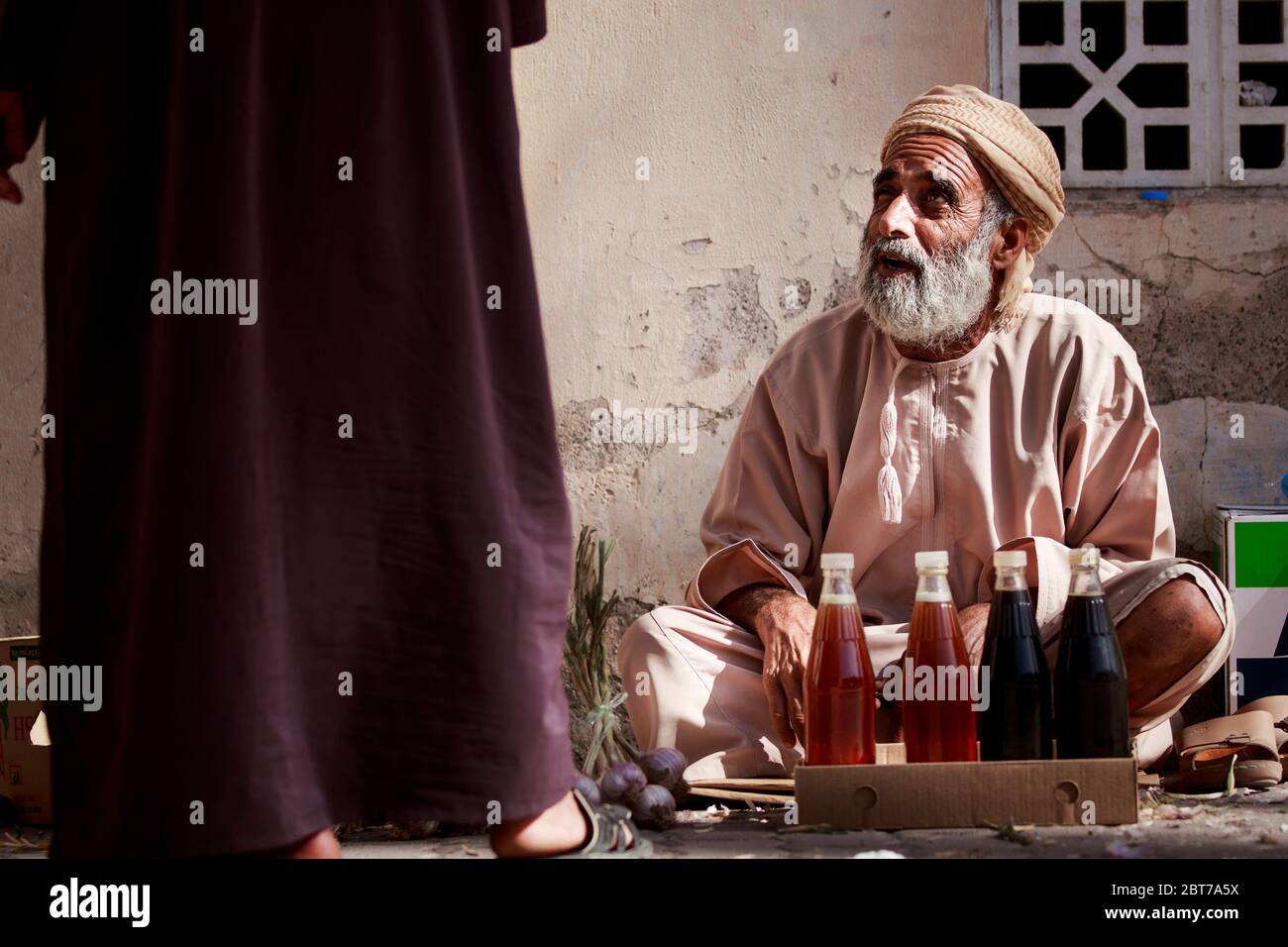 Omani old man selling honey and garlic at the traditional market or ...