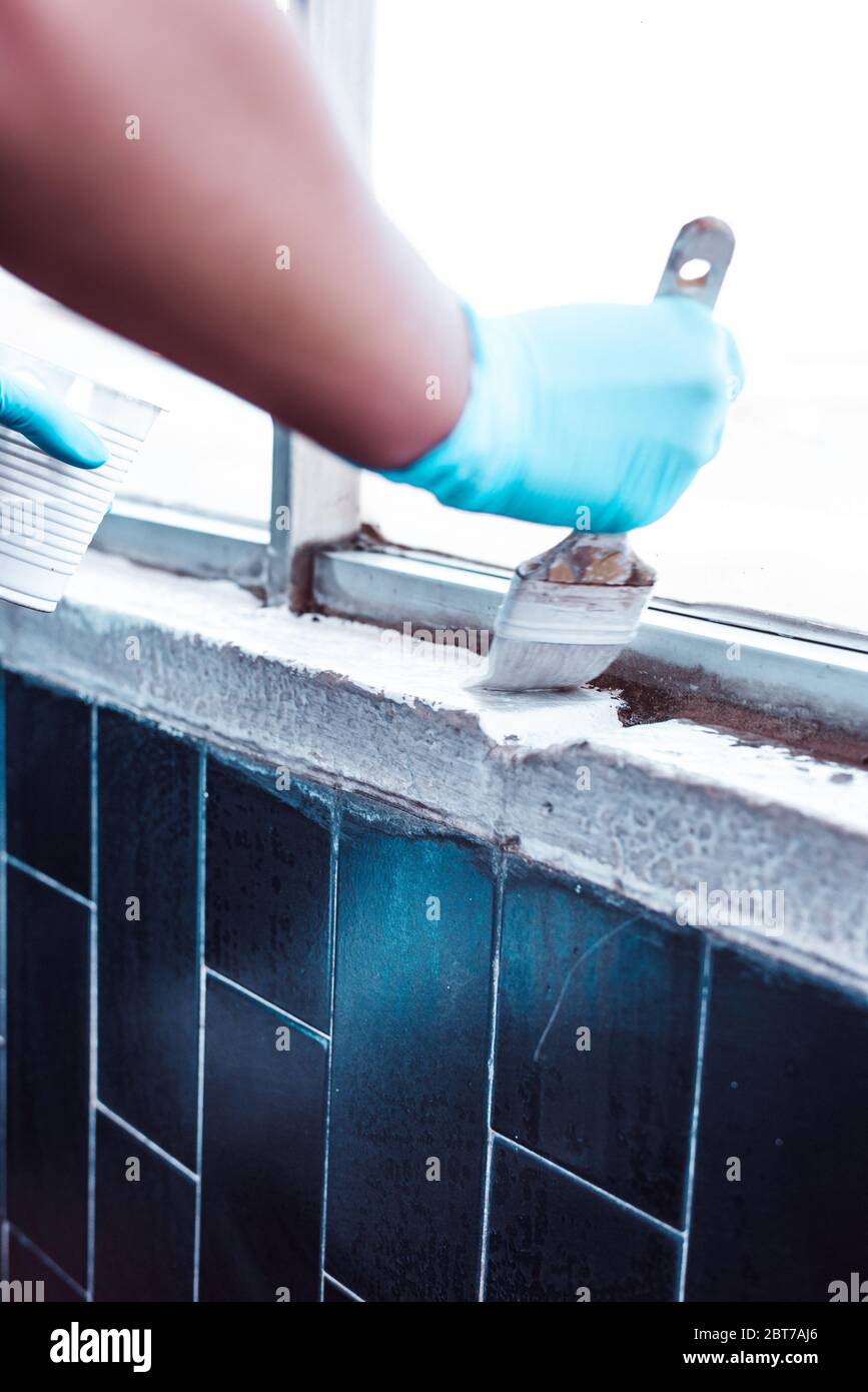 Hands in gloves painting a white wall Stock Photo - Alamy