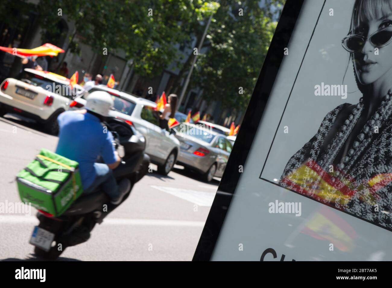 Madrid, Spain. 23rd May, 2020. A food delivery boy with a Spanish flag ...