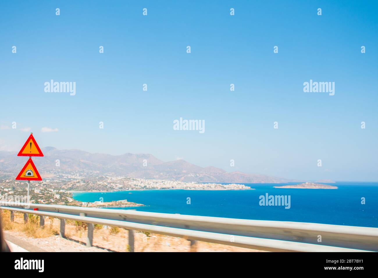 Beautiful view of the sea from the car window. Road Signs and fences on ...
