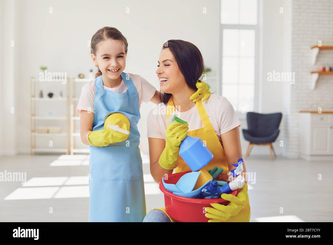 Happy family cleans the room in the house. Mother and girl kid clean ...