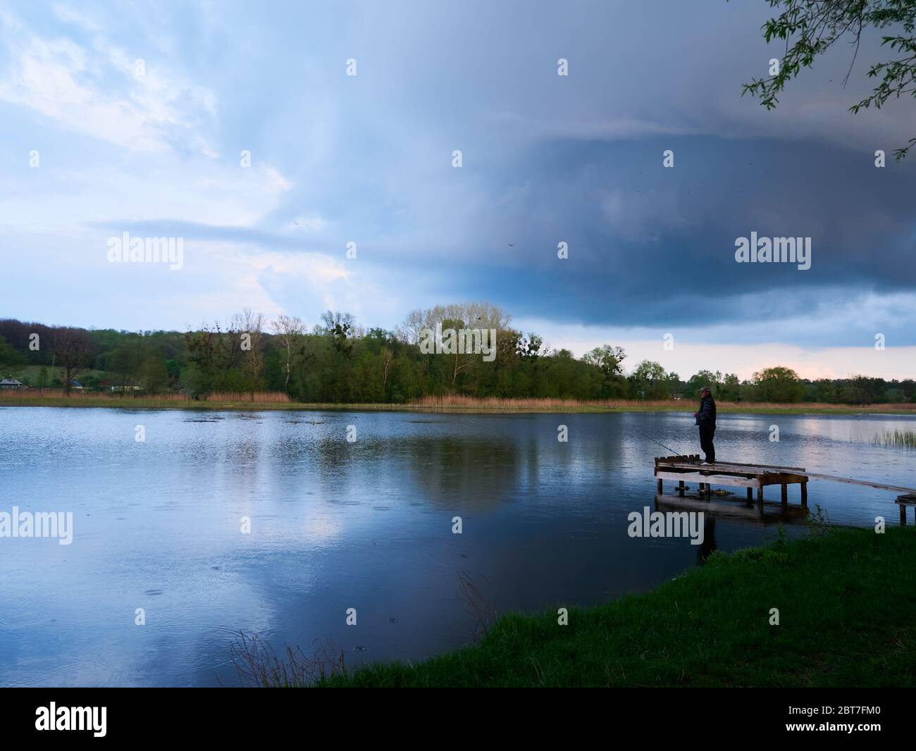 Man fishing under Heavy Stormy sky clouds. Ominous dramatic sky ...