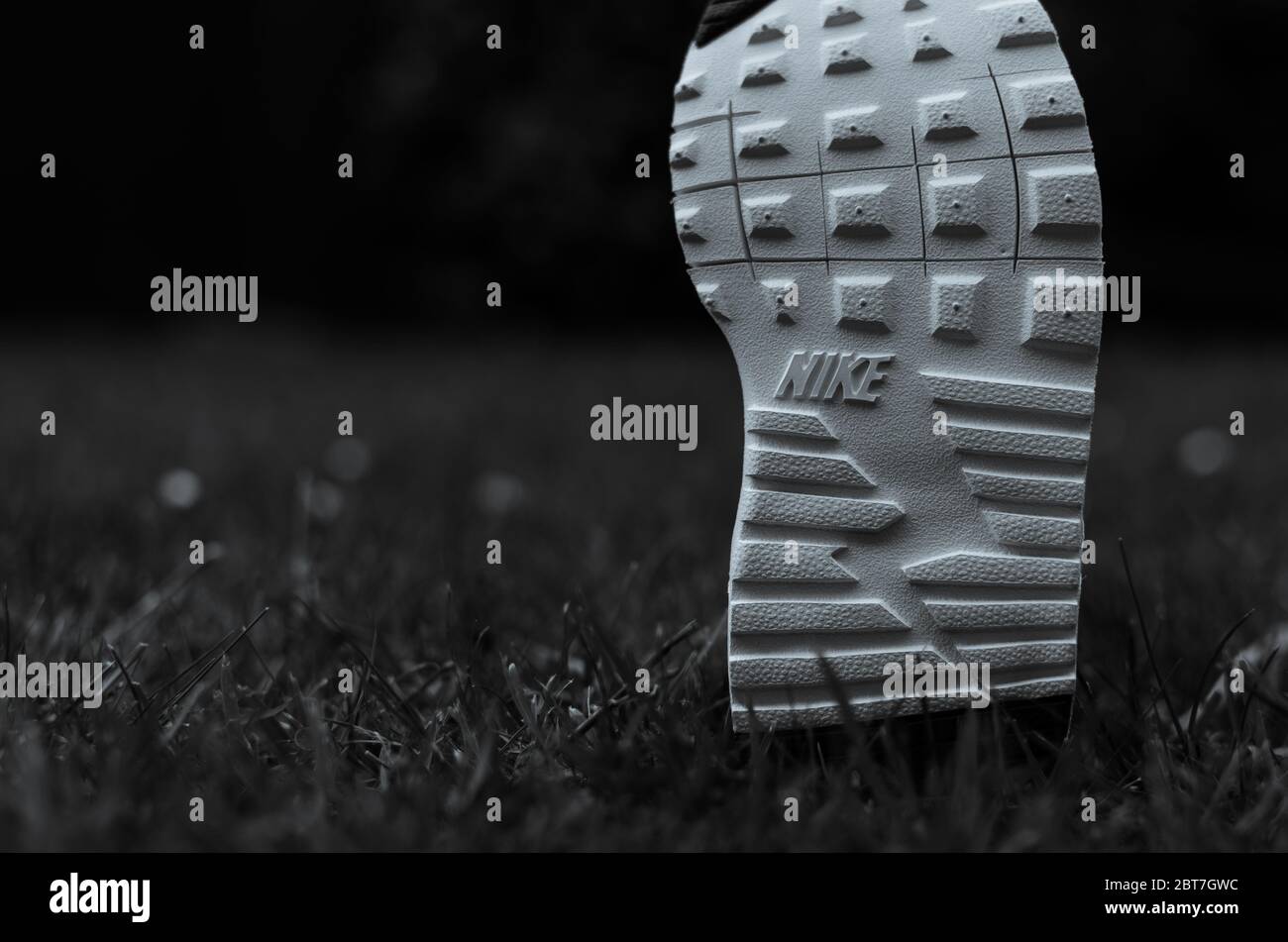 The close up photo of child's Air Nike trainer sole on the grass. Black ...