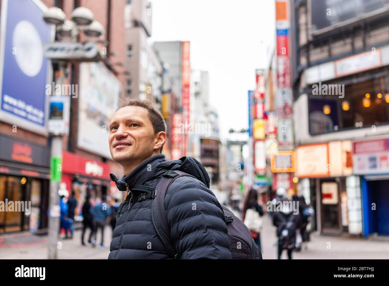 Tokyo, Japan Shibuya district with closeup of happy man tourist in ...
