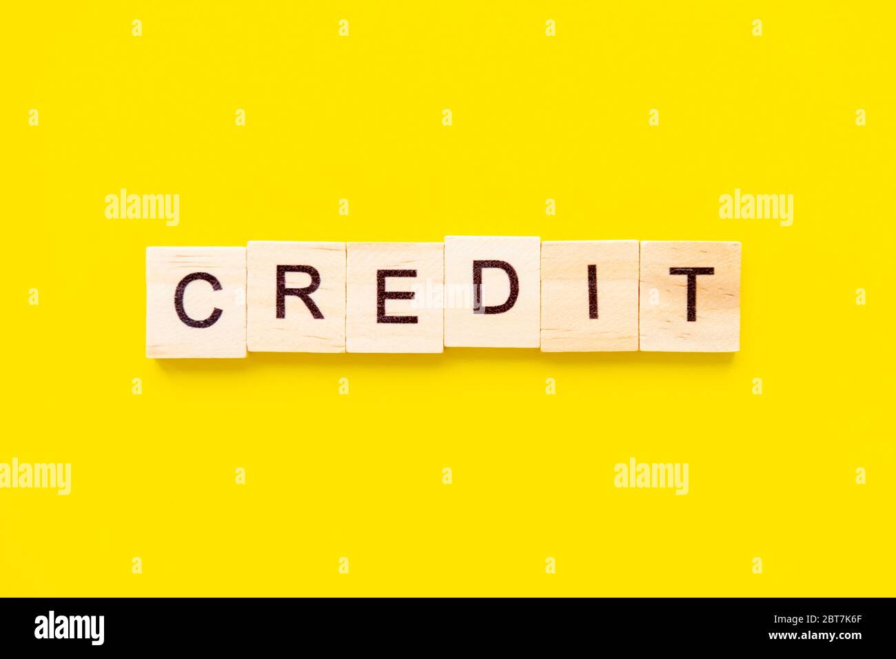 Wooden blocks with the lettering word credit on top of yellow ...