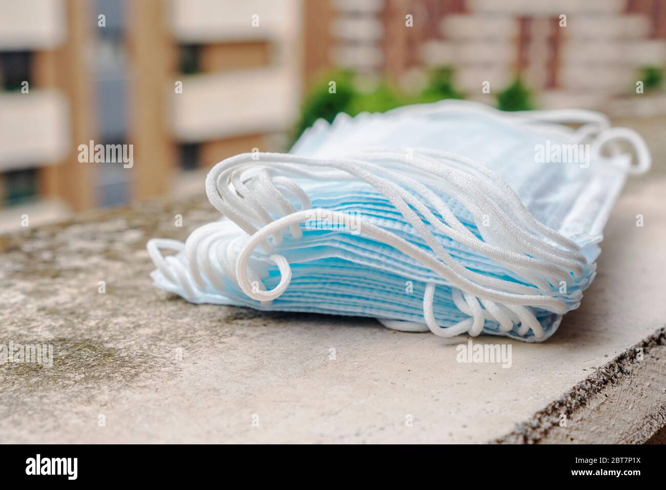 Medical protective surgical masks on an old concrete windowsill against ...