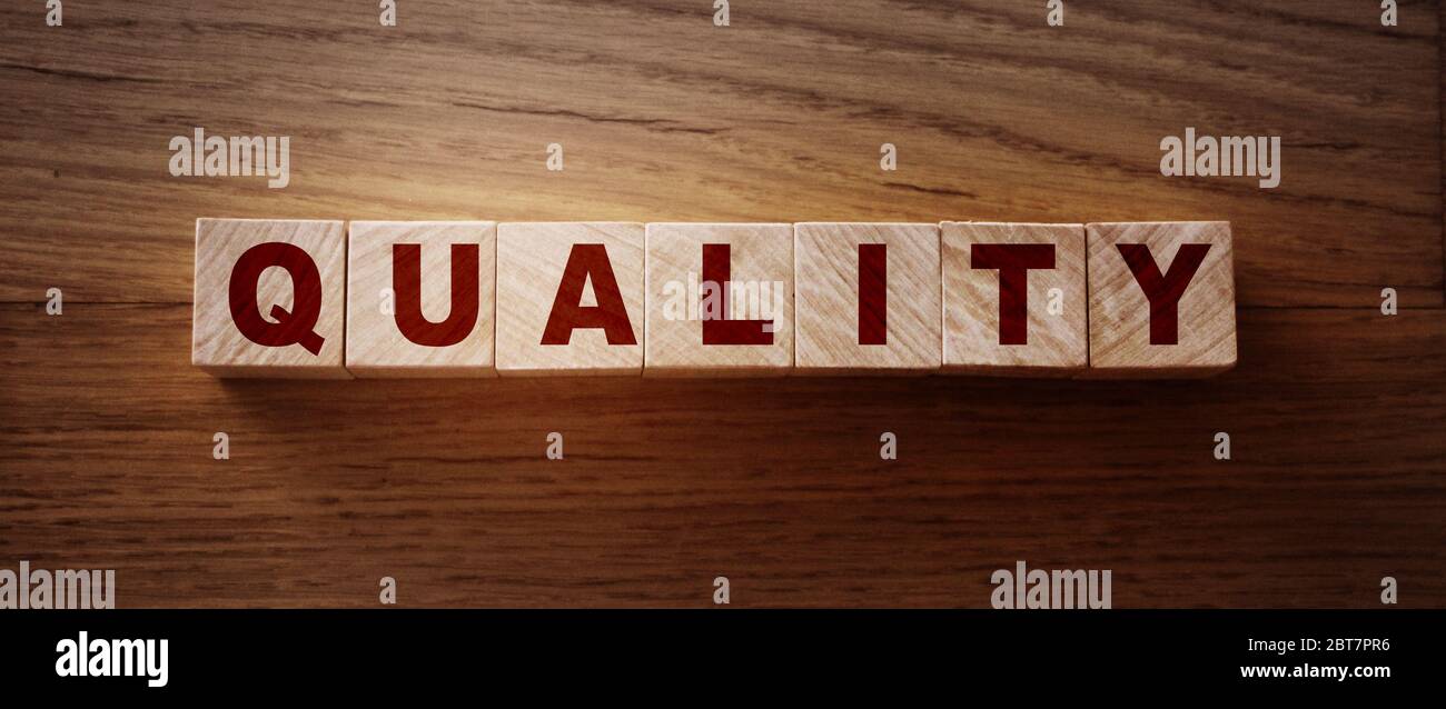 Word QUALITY on wooden cubes on wood background. Evaluation of good or ...