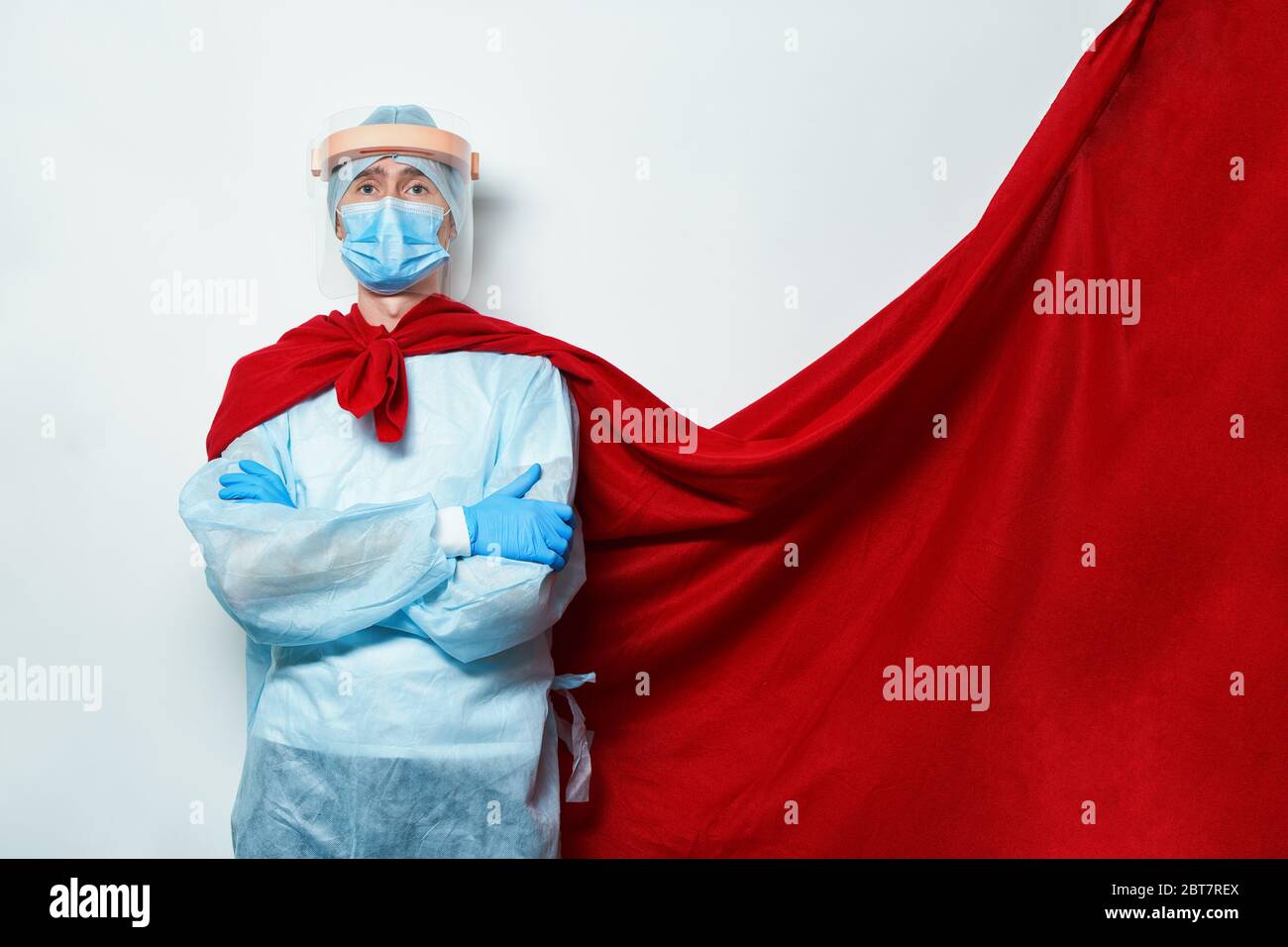 Doctor wearing surgical face mask in superhero cape. Concept of super ...