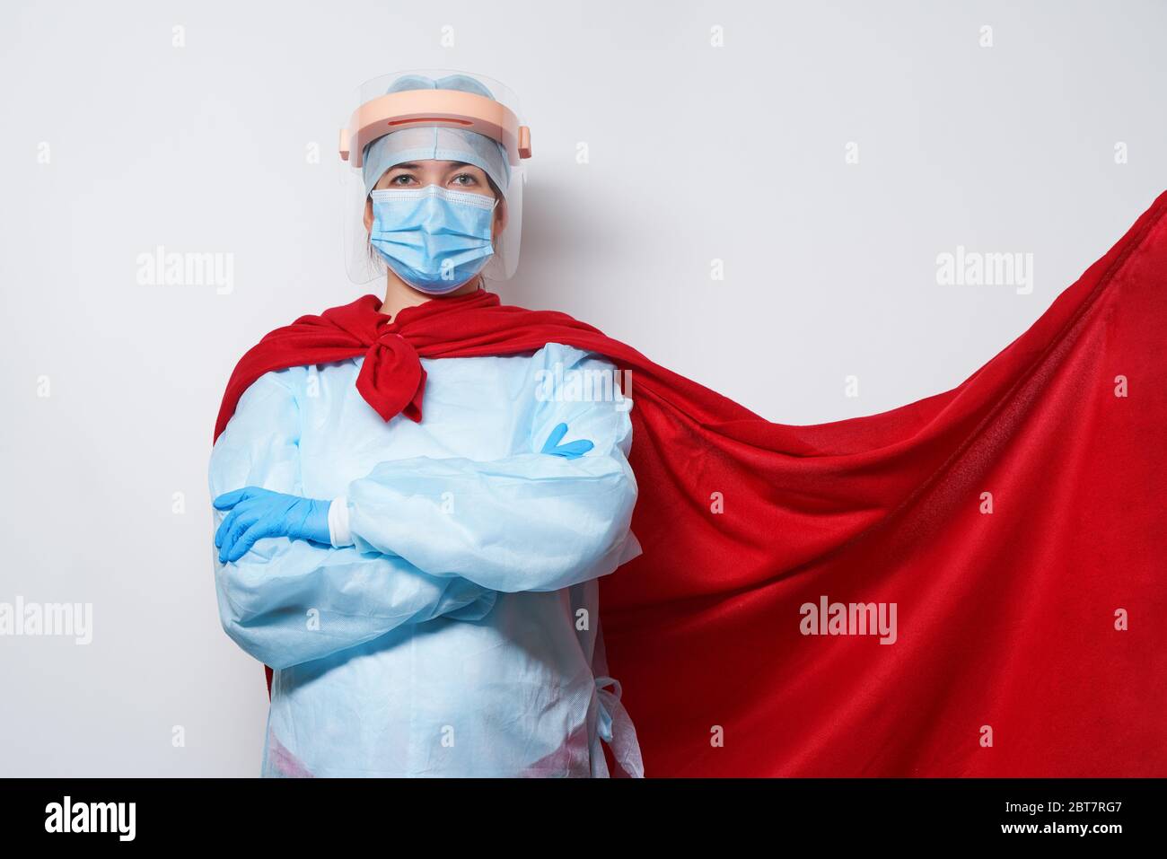 Doctor wearing surgical face mask in superhero cape. Concept of super ...